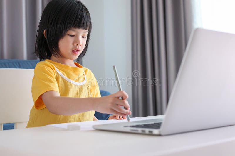 Little Asian Girl Student Study Online Using Laptop Computer at Home ...