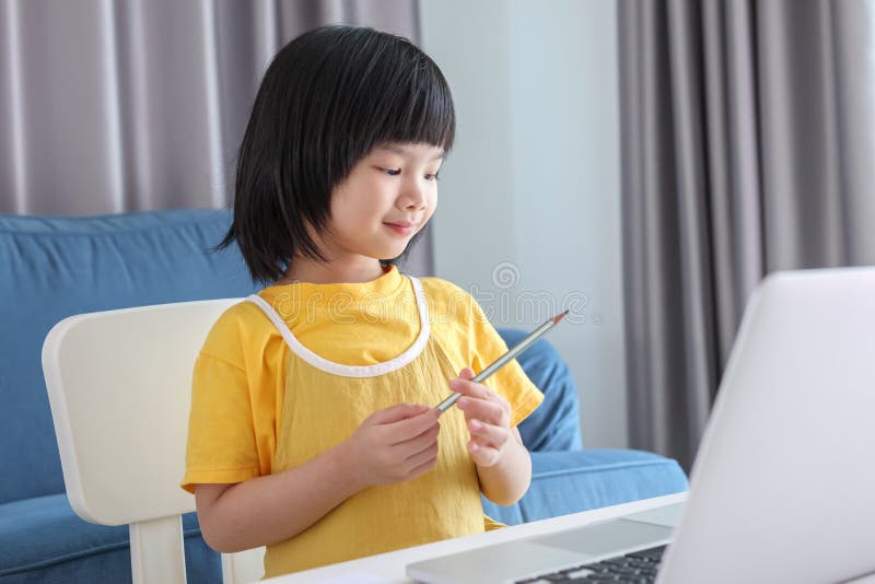 Little Asian Girl Student Study Online Using Laptop Computer at Home ...