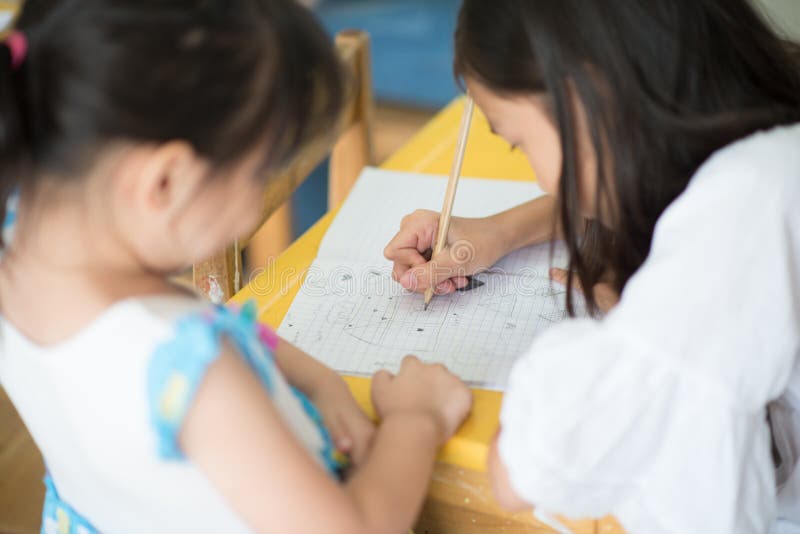 Little Asian Girl Writing in the Notebook School Stock Photo - Image of ...