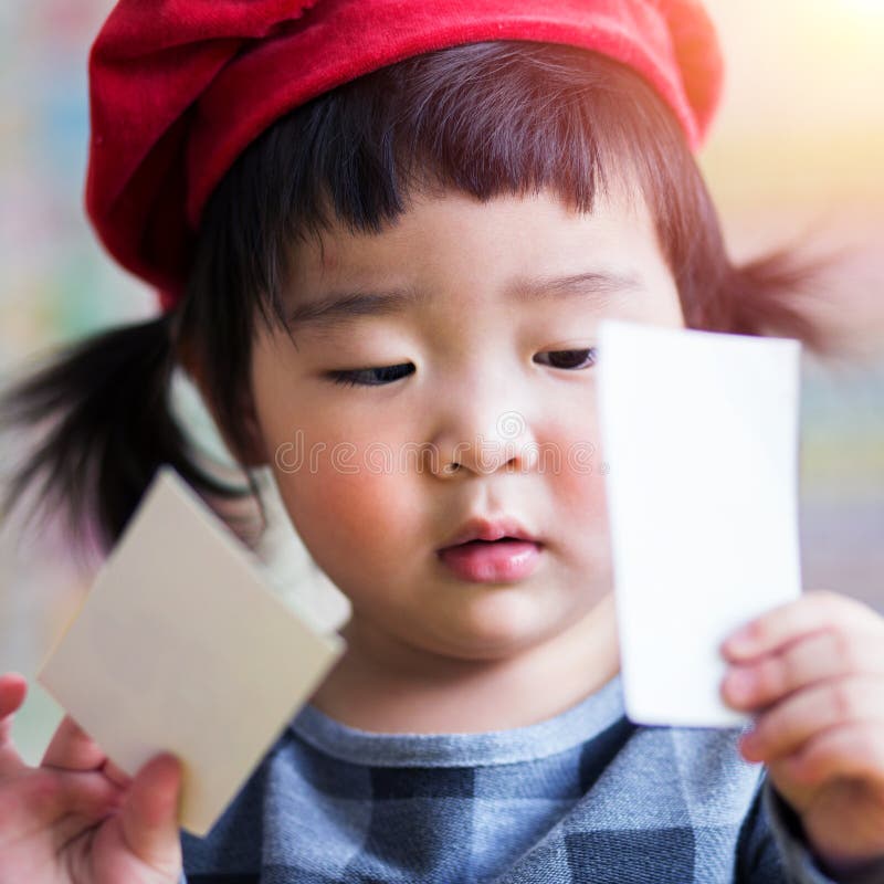 Adorable Asian Child Looking At Camera Innocently Stock Photo - Image ...