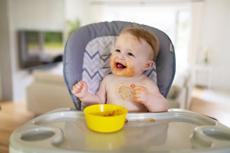 A Little Baby Eating Her Dinner and Making a Mess Stock Photo - Image ...