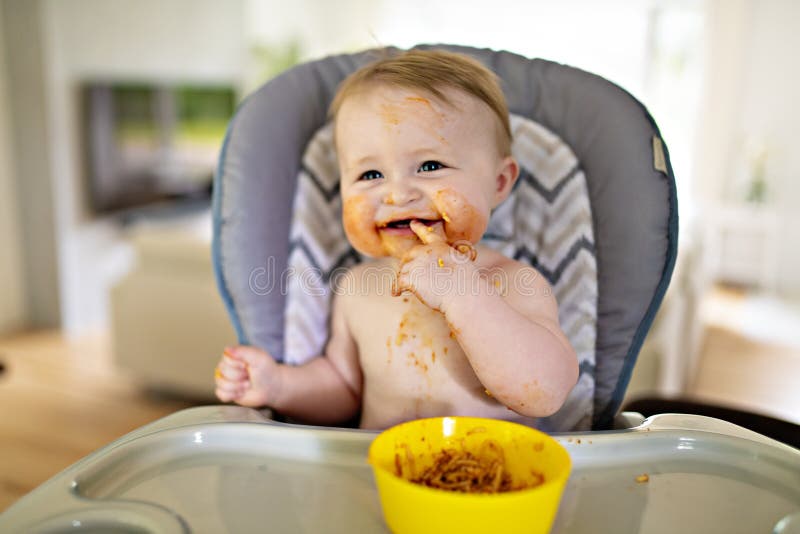 A Little Baby Eating Her Dinner and Making a Mess Stock Photo - Image ...