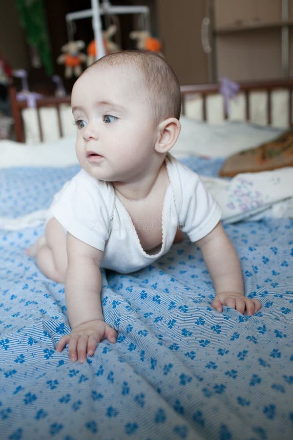 Little baby on the bed stock image. Image of play, baby - 240793041