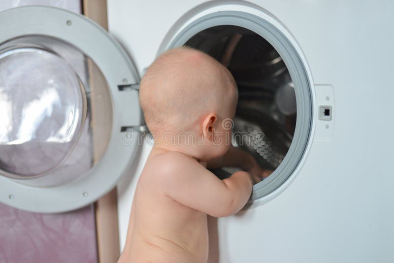 Little Baby Boy Loading Clothes into Washing Machine Stock Image ...