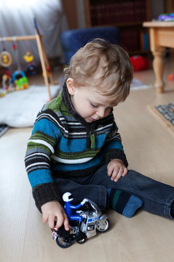 Little Baby Boy Playing with a Motorcycle Stock Image - Image of augen ...