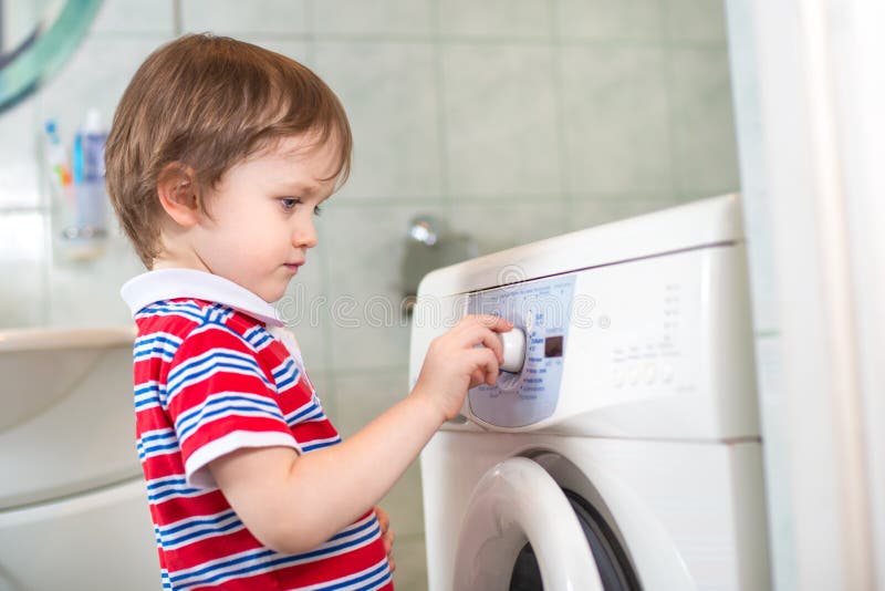 Little Baby Boy Programming Washing Machine in Bathroom Stock Image ...