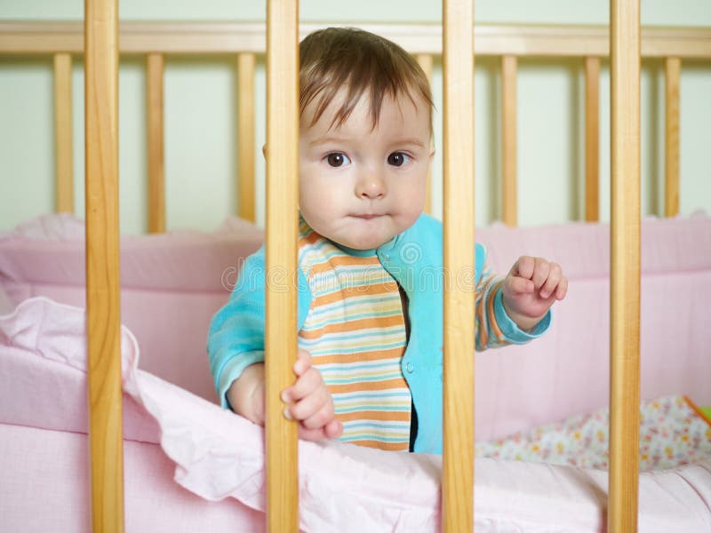 Little baby in a cot. stock photo. Image of curious, concentrated ...