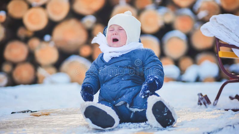 A Little Baby is Crying Sitting in the Snow. Stock Photo - Image of ...