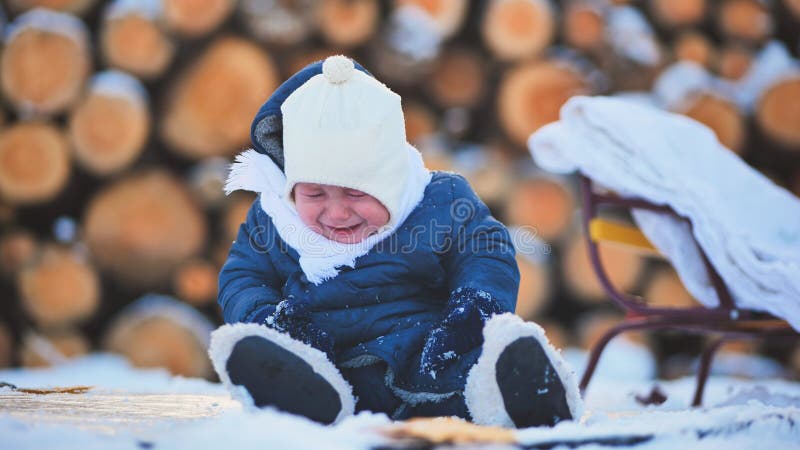 A Little Baby is Crying Sitting in the Snow. Stock Photo - Image of ...