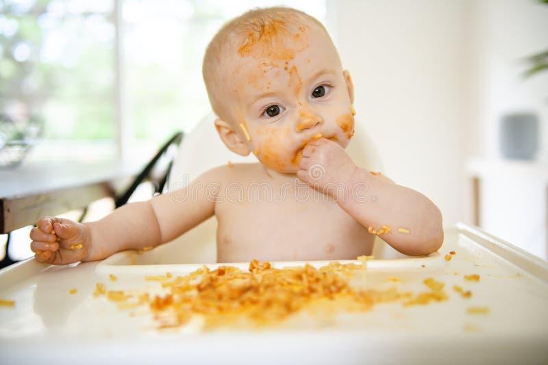 A Little Baby Eating Her Dinner and Making a Mess Stock Photo - Image ...