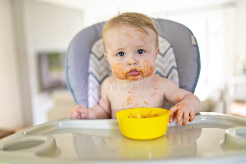 A Little Baby Eating Her Dinner and Making a Mess Stock Photo - Image ...