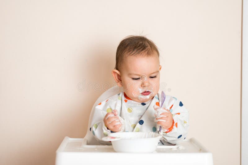 A Little Baby Eating Her Dinner and Making a Mess Stock Image - Image ...