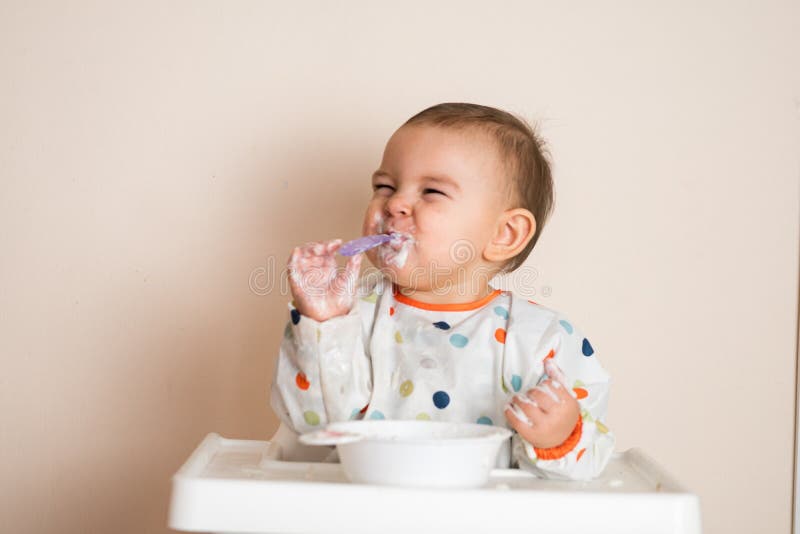 A Little Baby Eating Her Dinner and Making a Mess Stock Photo - Image ...