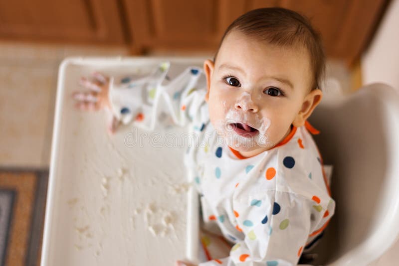 A Little Baby Eating Her Dinner and Making a Mess Stock Photo - Image ...