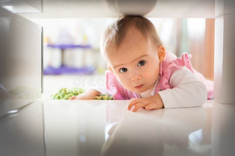 Little Baby Girl Crawl into Tight Space Under Coffee Table Stock Image ...