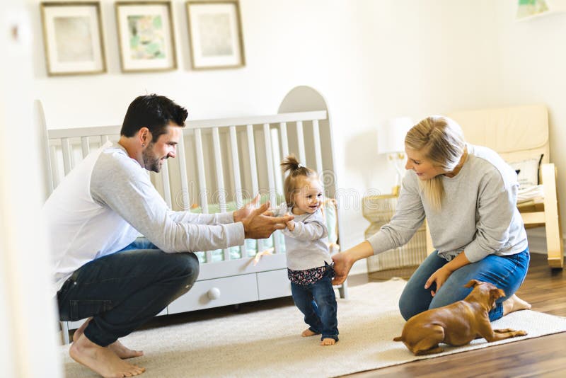 Little Baby Girl First Steps with the Help of Parent Stock Image ...