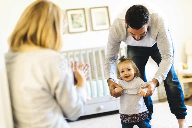 Little Baby Girl First Steps with the Help of Parent Stock Image ...
