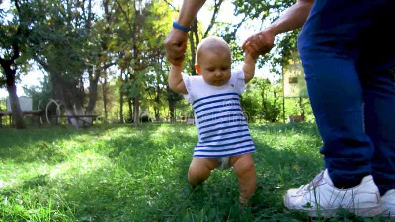 Little Baby Learns To Walk. First Steps. Parents are Teaching Their ... Little Baby Learns To Walk. First Steps. Parents are Teaching Their ...