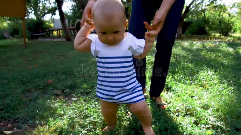 Little Baby Learns To Walk. First Steps. Parents are Teaching Their ... Little Baby Learns To Walk. First Steps. Parents are Teaching Their ...