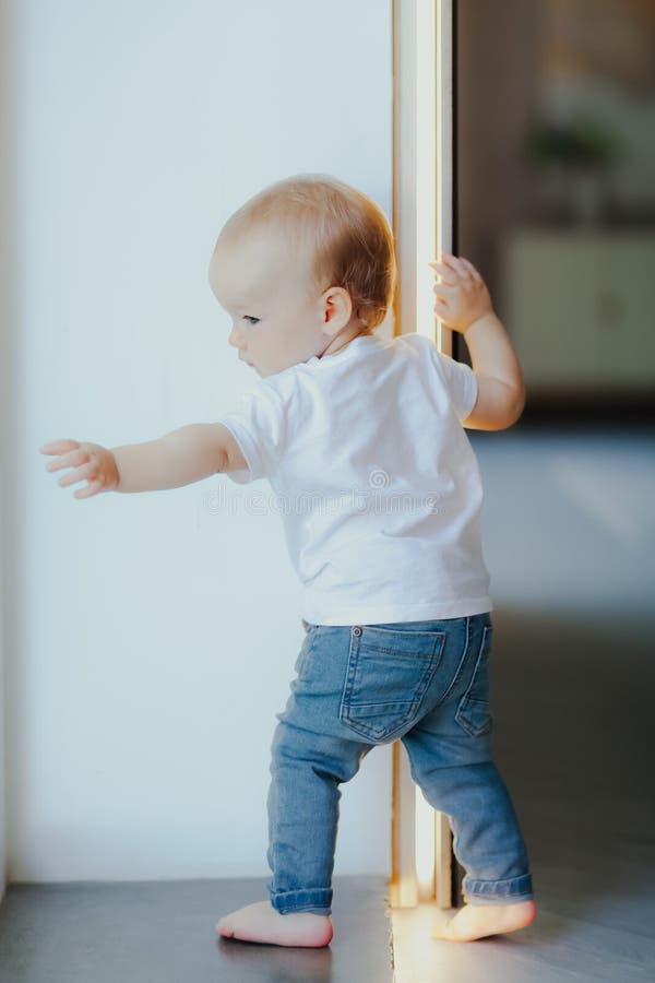 Little baby learns to walk stock photo. Image of year - 217984000