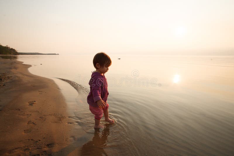 Little baby near the lake stock image. Image of people - 66875815