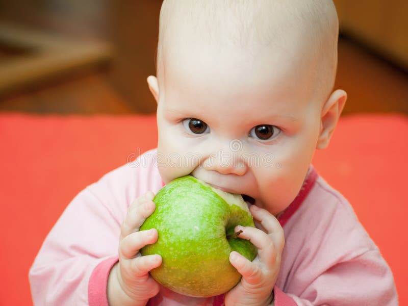 Little Baby in Pink Jacket Eats Green Apple Stock Photo - Image of ...