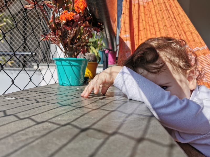 Little Baby in Summer on the Balcony Behind the Safety Net Stock Photo ...