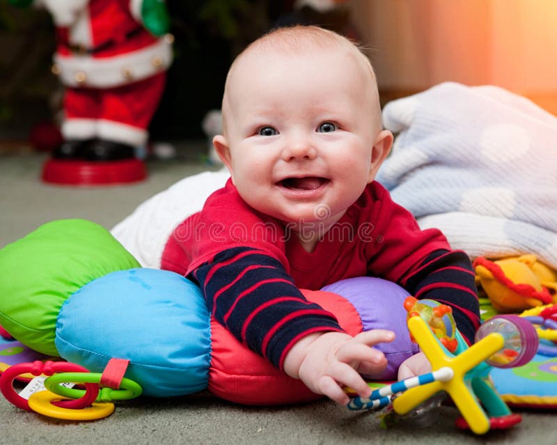 Little Baby Under Christmas Tree, Smiling and Playing Stock Image ...