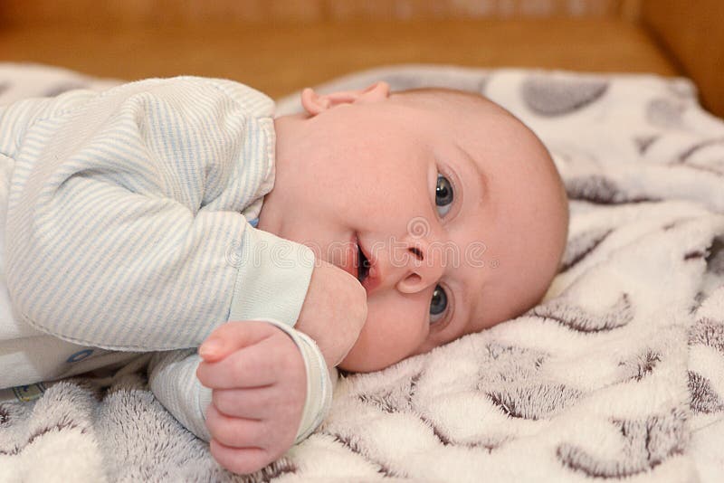 Little Beautiful Baby is Thinking Stock Photo - Image of lying ...