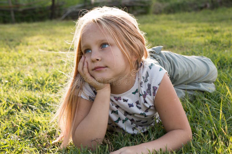 Girl In A Summer Park Lies On The Grass Stock Image Image Of
