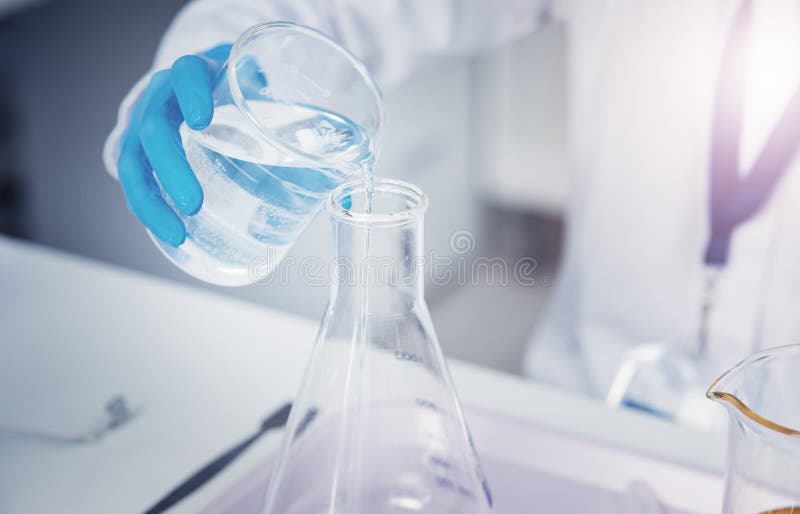 A Little Bit of this. Closeup of an Unrecognizable Scientist Adding a ...