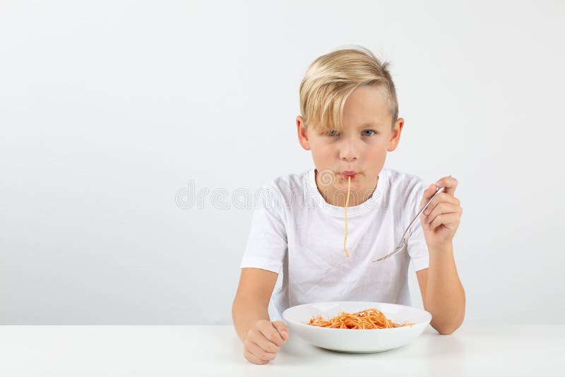 Little Blond Boy in Front of White Background Eats Spaghetti Stock ...