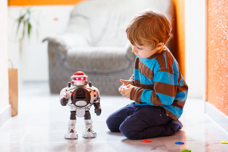 Little Blond Boy Playing with Robot Toy at Home, Indoor. Stock Image ...