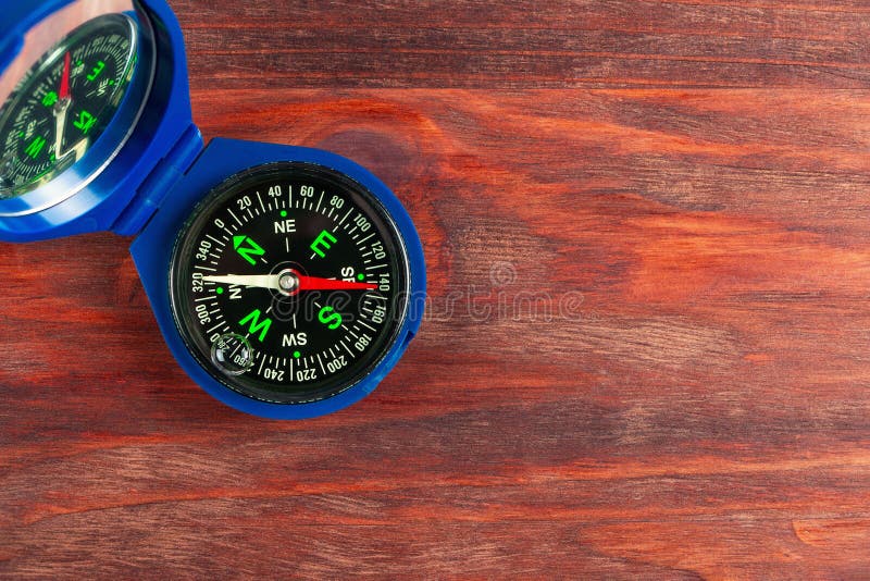 Little Blue Compass on Wooden Surface Stock Photo - Image of travel ...