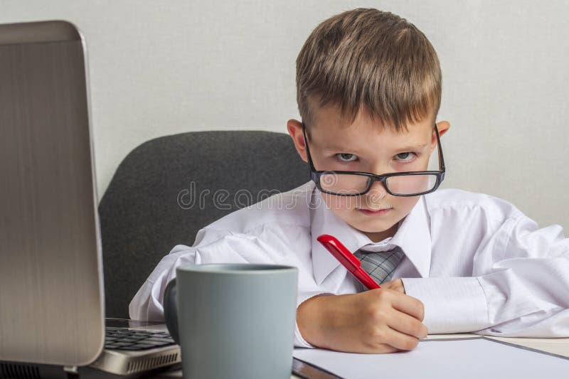 Little Boss in the Office. a Kid Businessman with Glasses Working with ...
