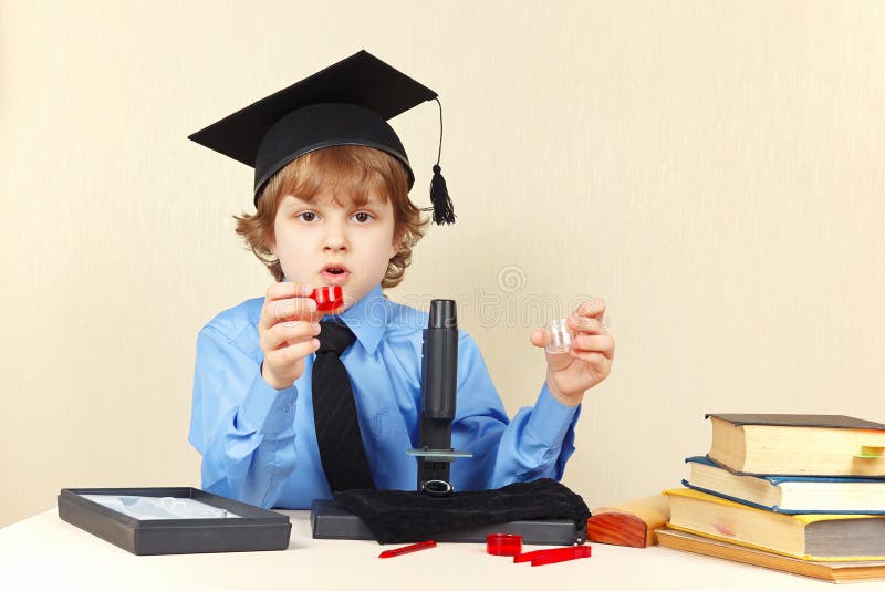 Little Boy in Academic Hat with the Jars for Research Next To ...
