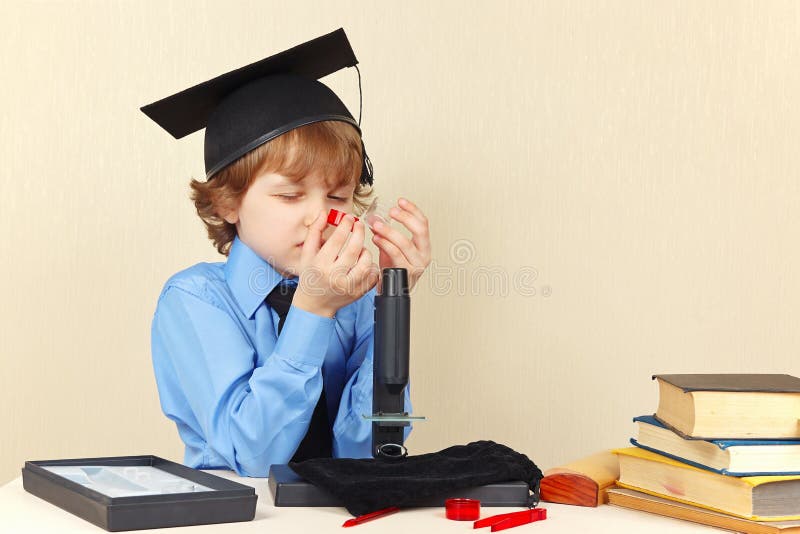 Little Boy in Academic Hat Sees Jars for Research Next To Microscope ...