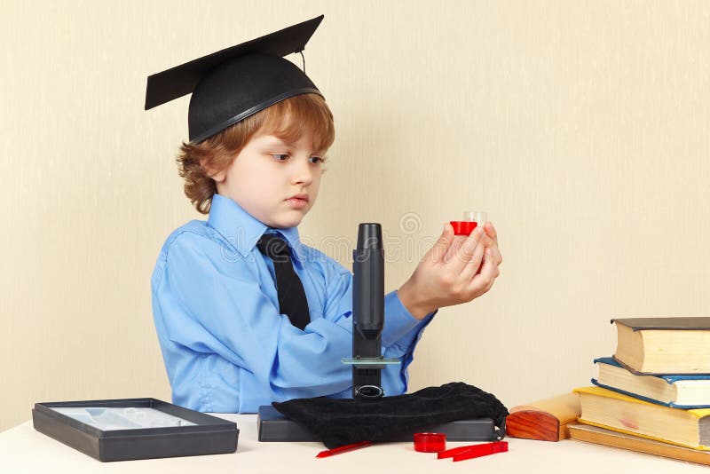 Little Boy in Academic Hat Sees the Results of Research Next To ...