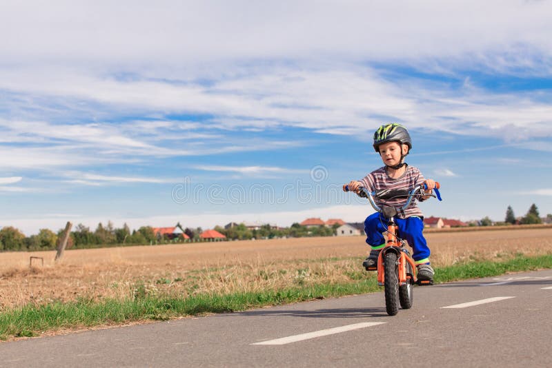 Little boy on a bicycle. stock image. Image of little - 60145689