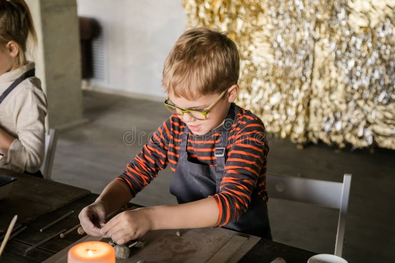 Little Boy in Big Glasses Sculpts from Clay with Interest Stock Photo ...