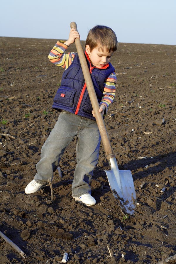 Little boy with big shovel stock photo. Image of cultivate - 19399862