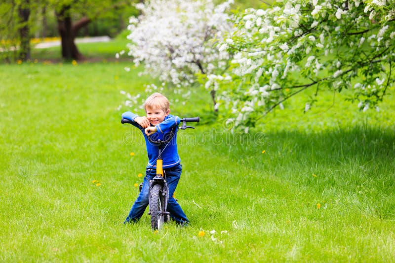 Little Boy Biking in Spring Garden Stock Photo - Image of blossom, baby ...
