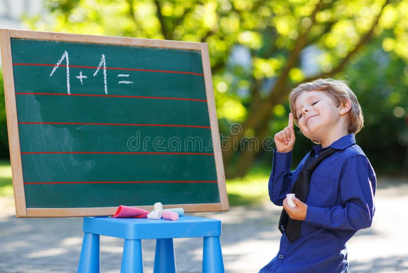 Little Boy at Blackboard Practicing Mathematics Stock Image - Image of ...