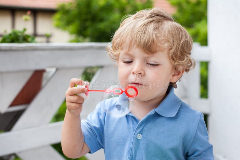 Little Boy Blowing Soap Bubbles Stock Photo - Image of blowing ...
