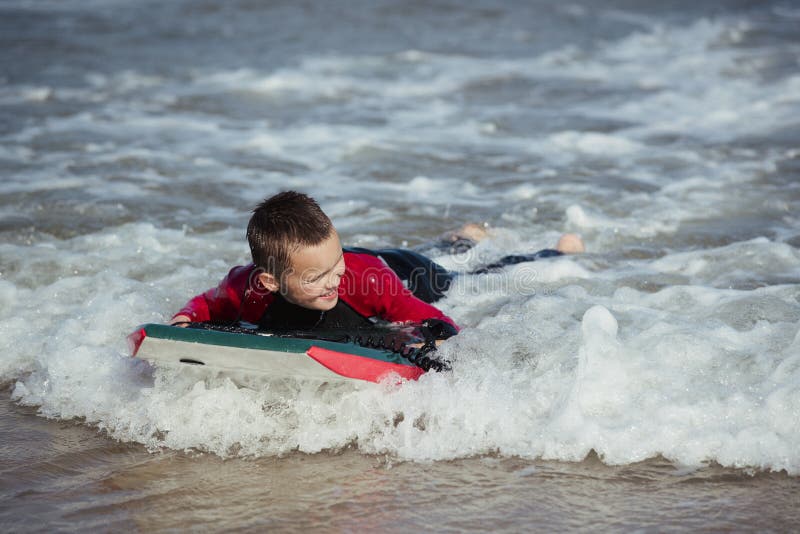 Little Boy Bodyboarding in the Sea Stock Image - Image of lifestyles ...