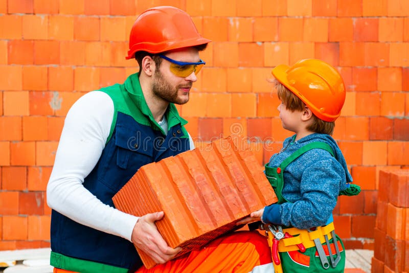 Little Boy Bricklayer. Brothers are Building Together Stock Photo ...