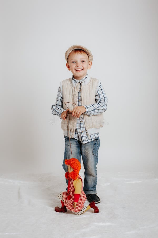 Little Boy in Cap Standing with a Puppet Doll Stock Photo - Image of ...