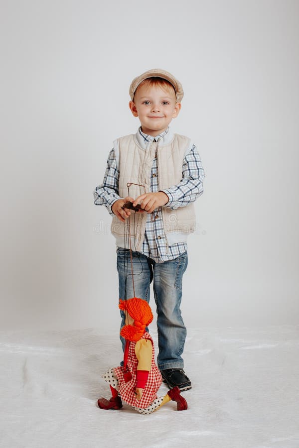 Little Boy in Cap Standing with a Puppet Doll Stock Photo - Image of ...