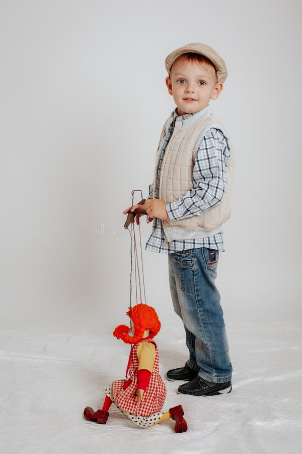 Little Boy in Cap Standing with a Puppet Doll Stock Image - Image of ...