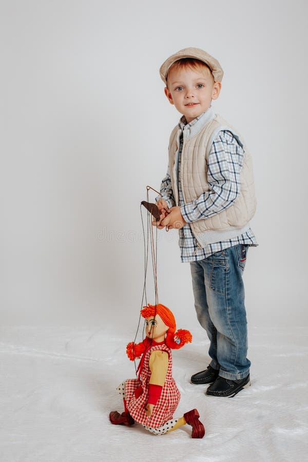 Little Boy in Cap Standing with a Puppet Doll Stock Photo - Image of ...